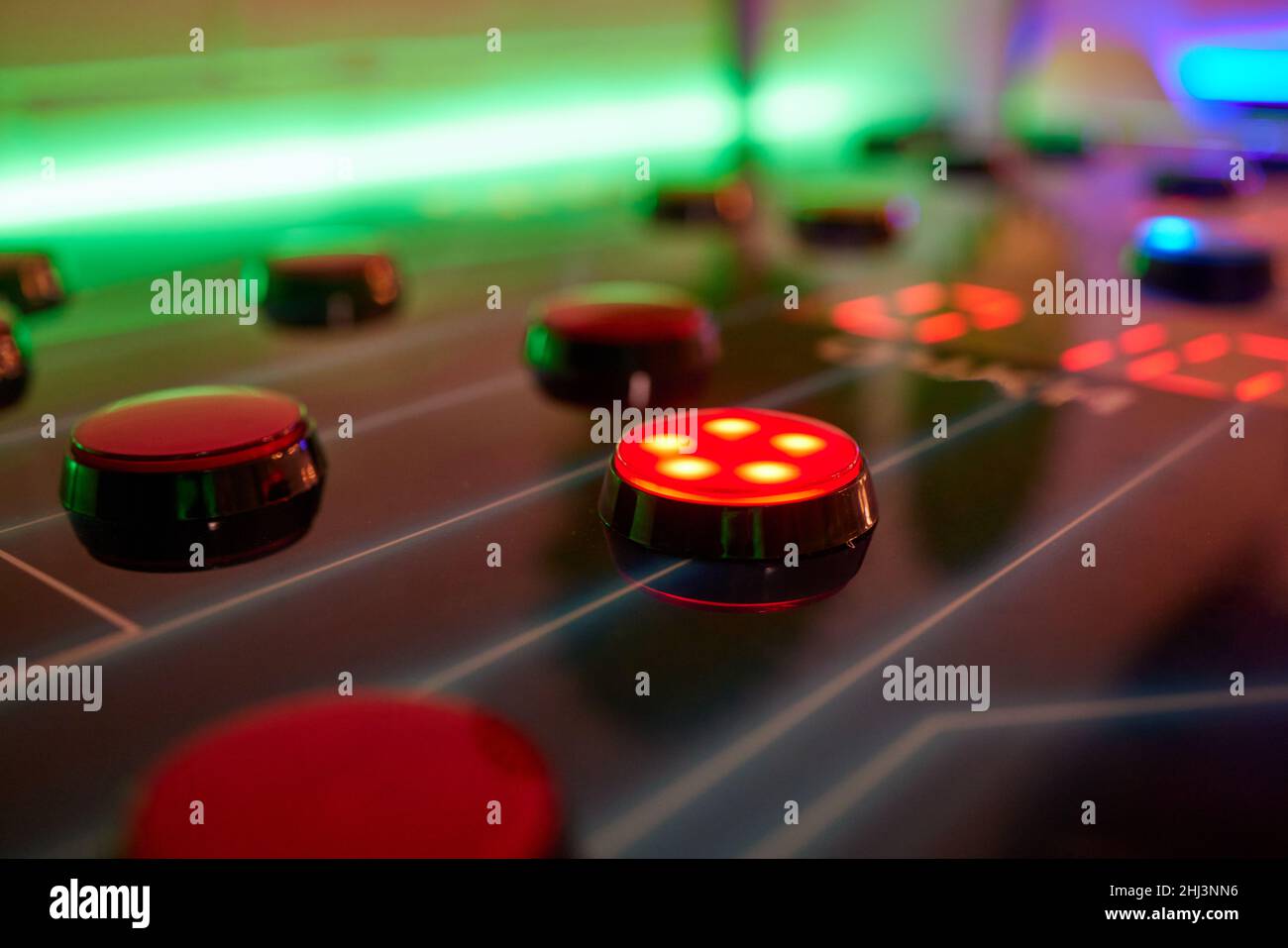 Joystick and button controls of a vintage arcade video game in a dark ...