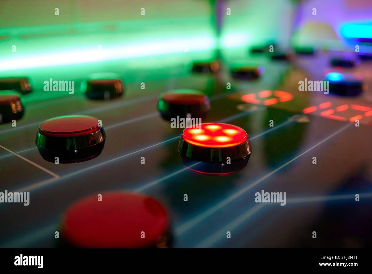 Joystick and button controls of a vintage arcade video game in a dark ...