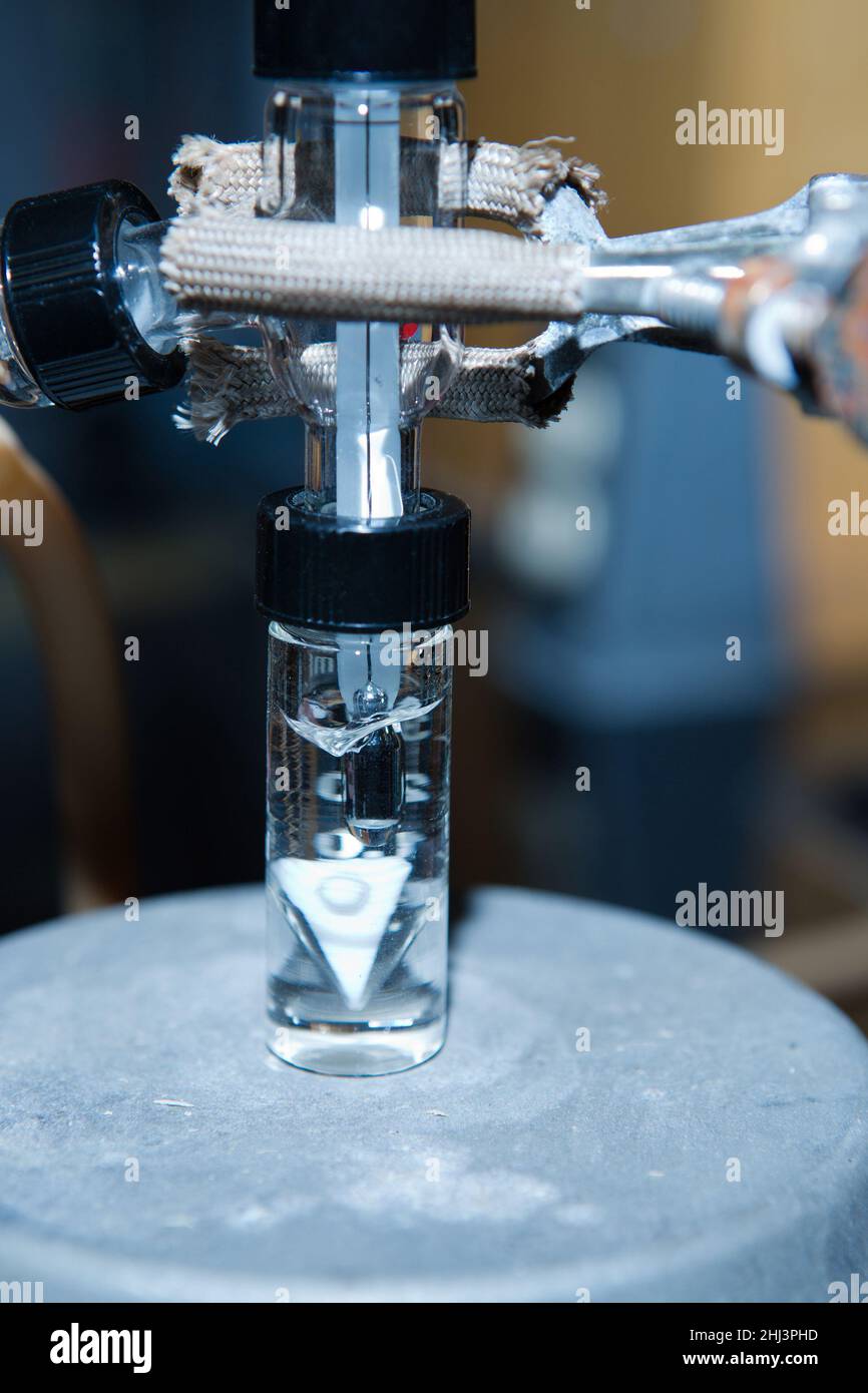 A solution mixing on a hot plate with a thermometer Stock Photo - Alamy