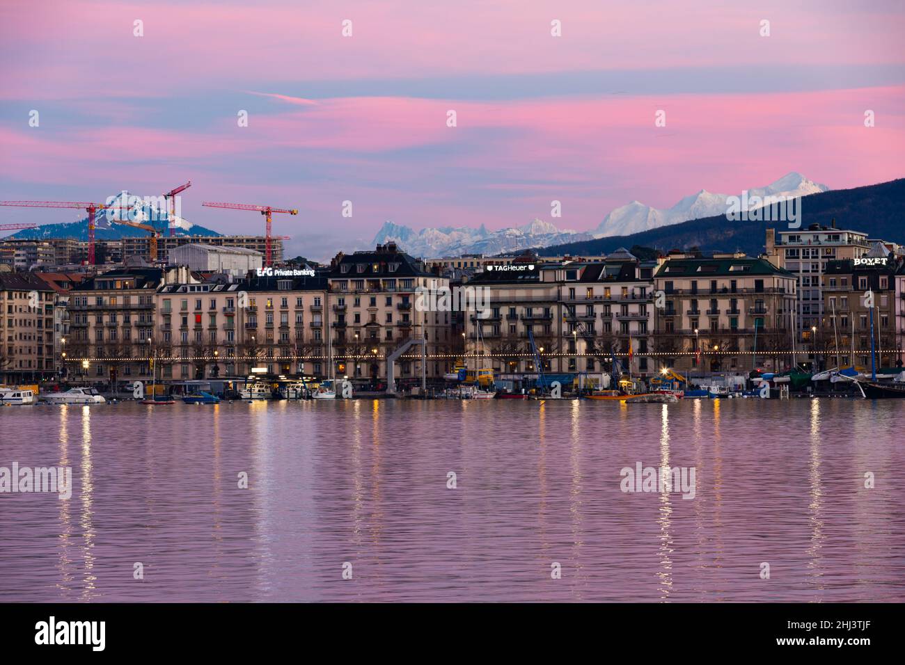 Geneva cityscape seen with lake and snow-capped mountains in background ...
