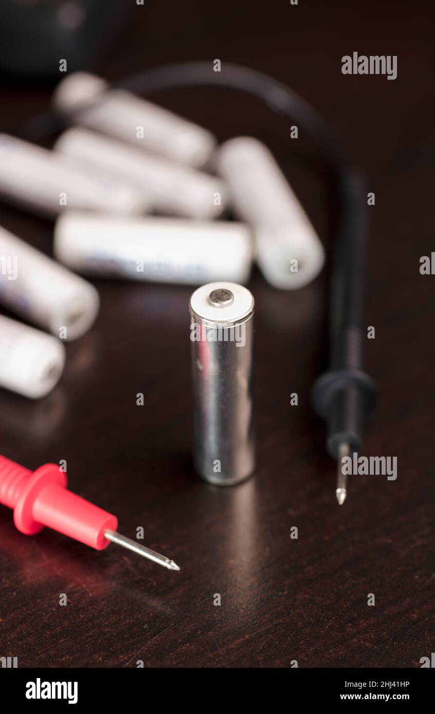 battery with volt meter, red positive pole, black negative pole, on ...