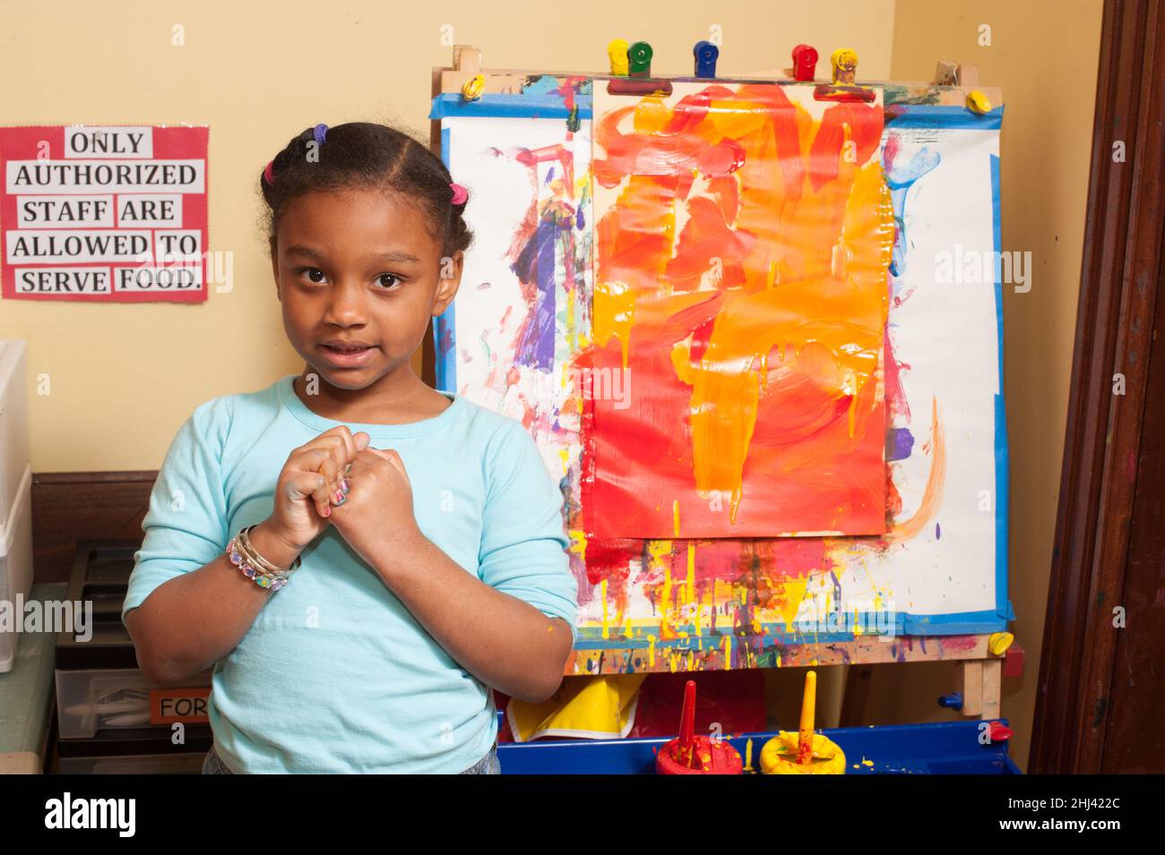 Education Preschool 4-5 year olds portrait of girl standing near easel ...