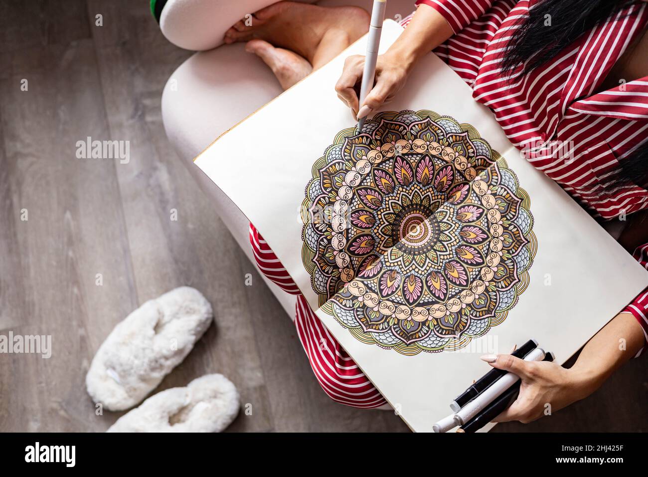 Happy young mother enjoying tidying up at female child wardrobe closet ...