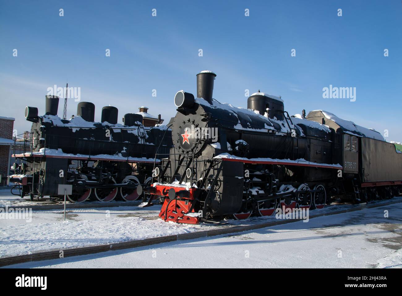 an old black Soviet Russian steam locomotive.military equipment in the ...