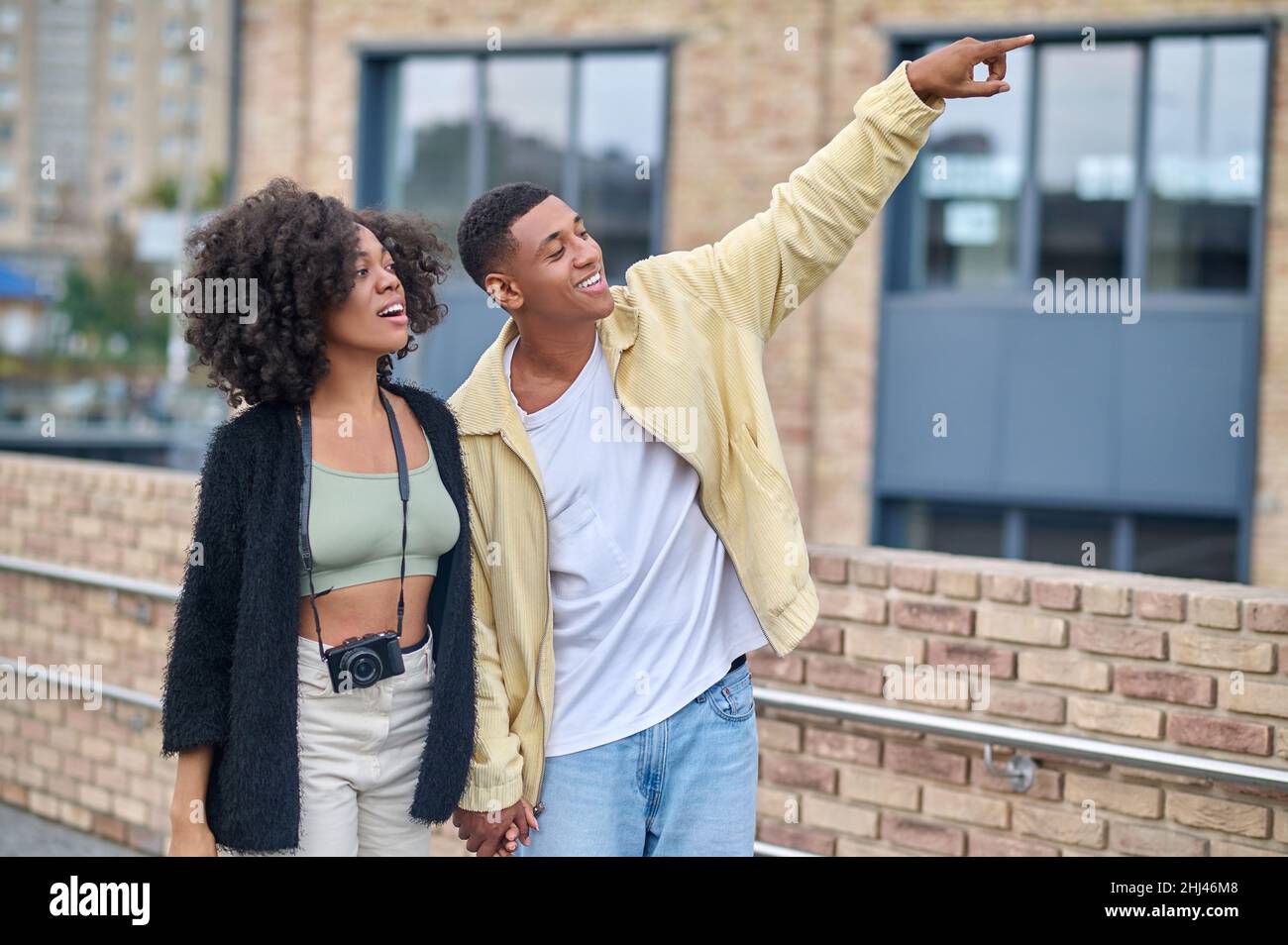 Man showing woman location on city street Stock Photo - Alamy