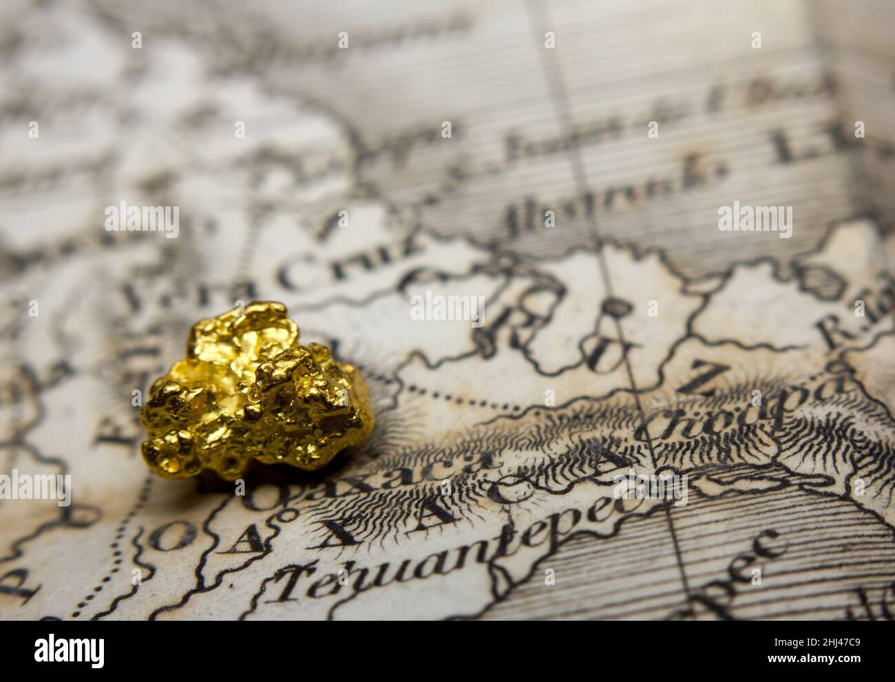 Close-up of a gold-nugget on top of a map of Mexico Stock Photo - Alamy