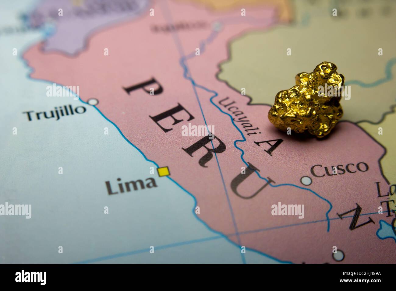 Close-up of a gold-nugget on top of a map of Peru Stock Photo - Alamy