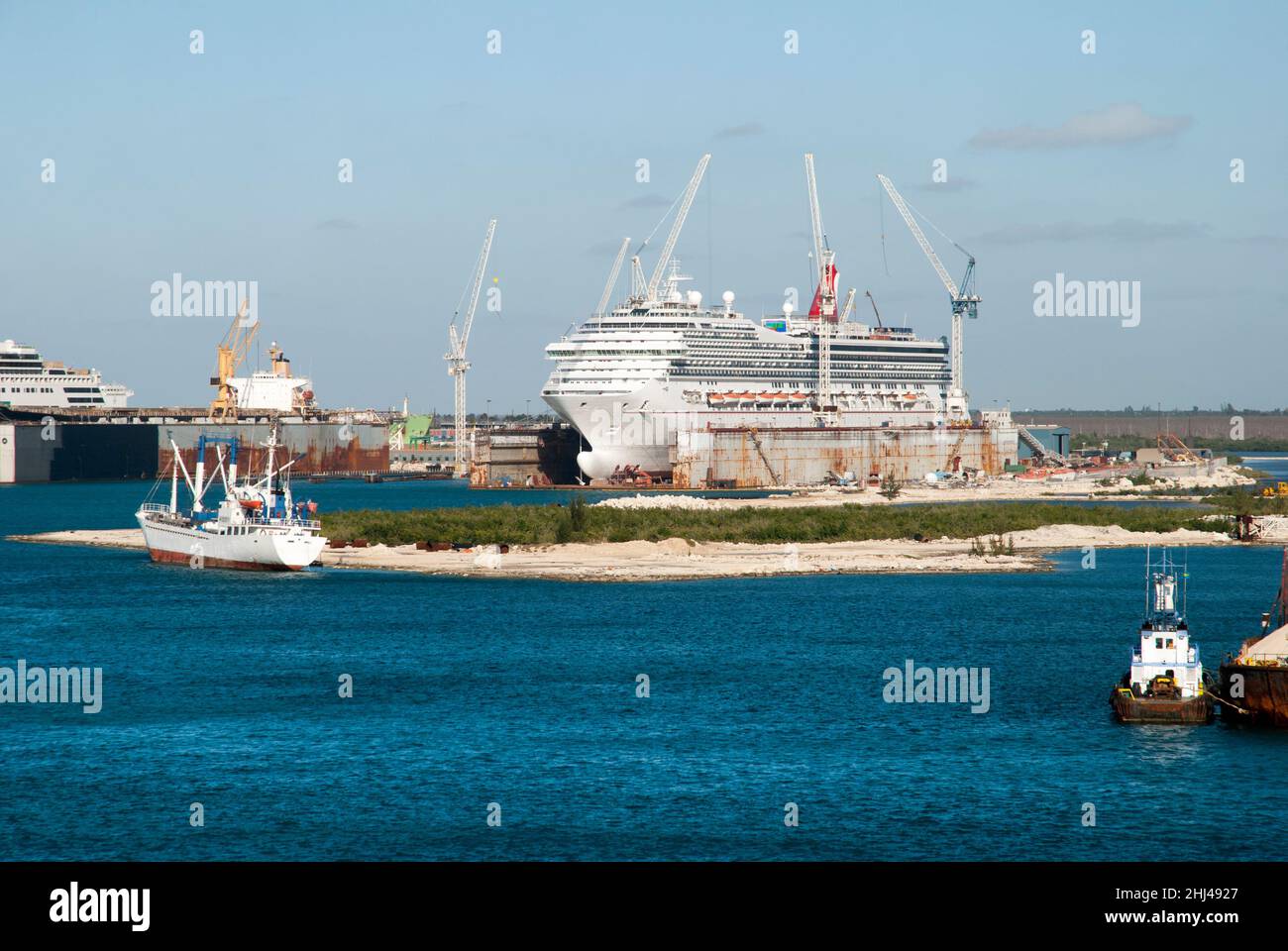 The cruise ship surrounded by cranes standing in a dry dock in Freeport ...