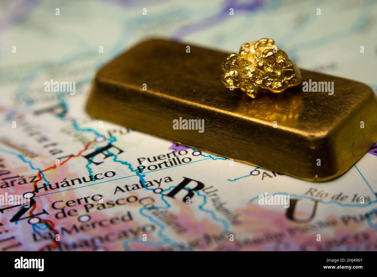 Close-up of a gold-bar and gold-nugget on top of a map of Peru Stock ...