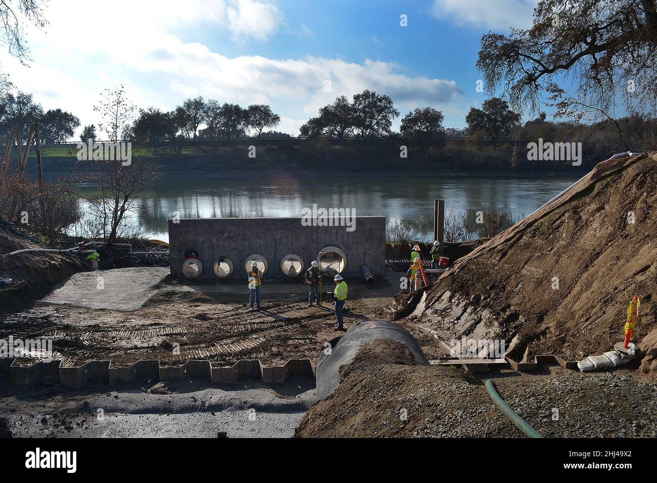 On the river side of Garden Highway, a concrete outfall structure is ...