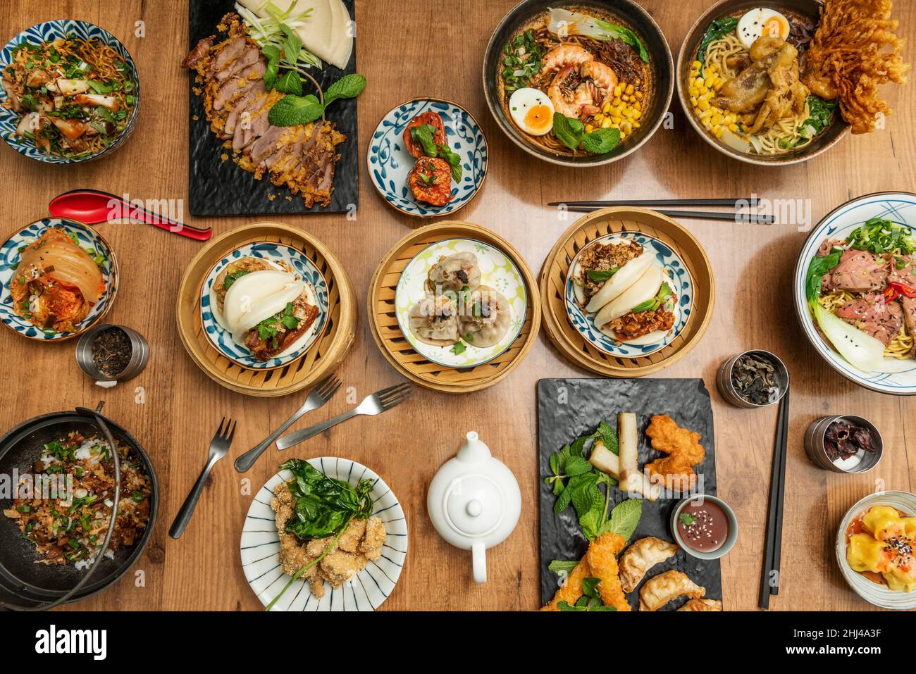Set of Asian food dishes, with fried gyozas, dumplings, soy sauce ...
