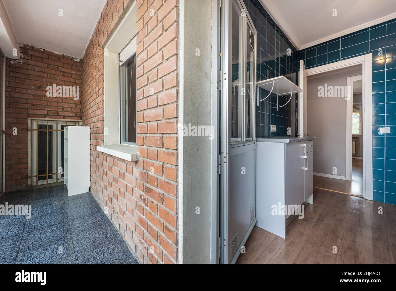 Conventional kitchen with white cabinets, gray countertop and small ...