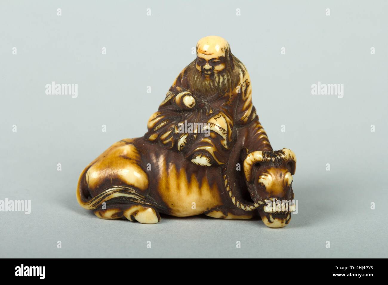 Netsuke of Man Sitting on a Recumbent Ox 19th century Japan. Netsuke of ...