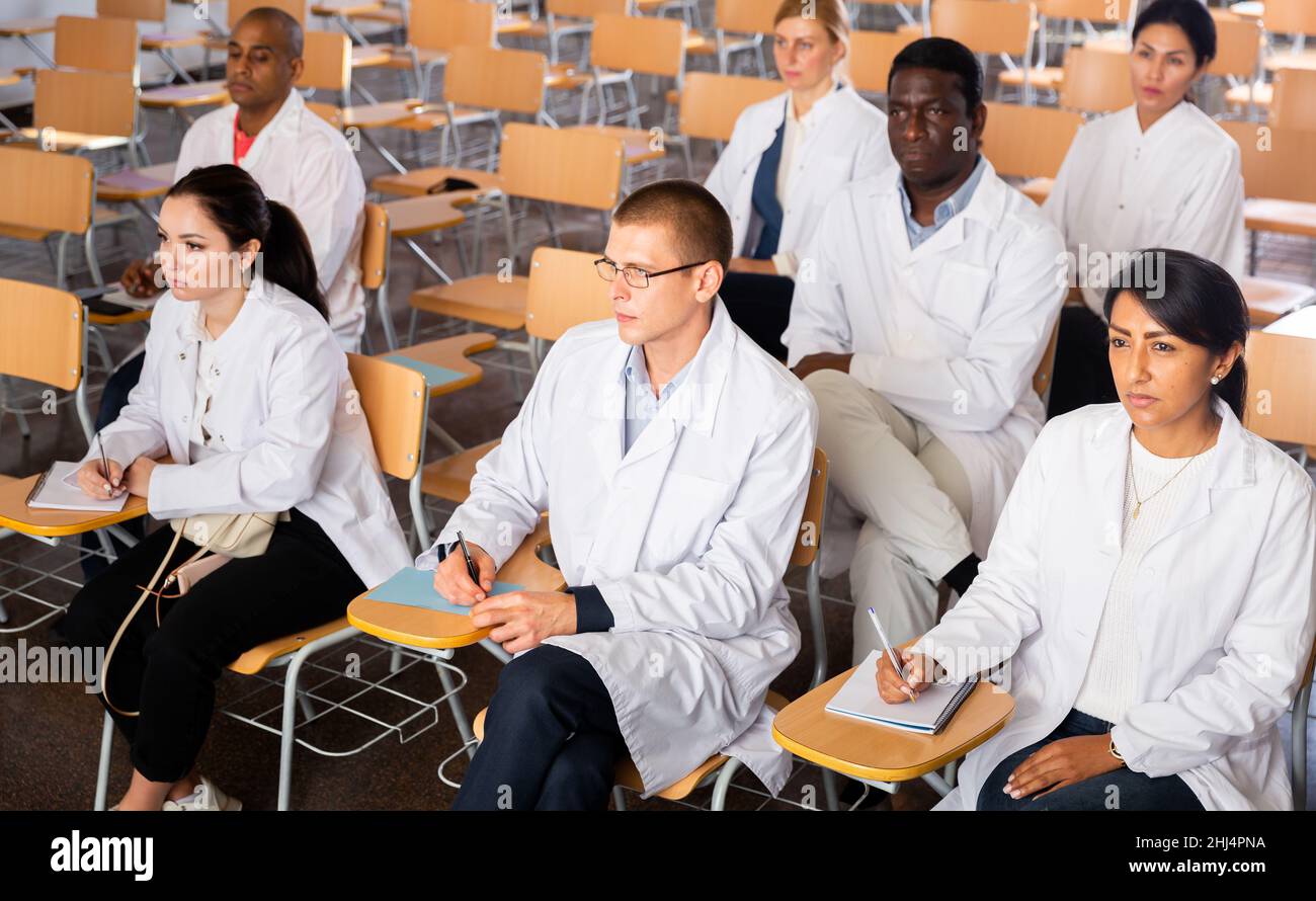 Group of people in white coats attending training for health workers ...