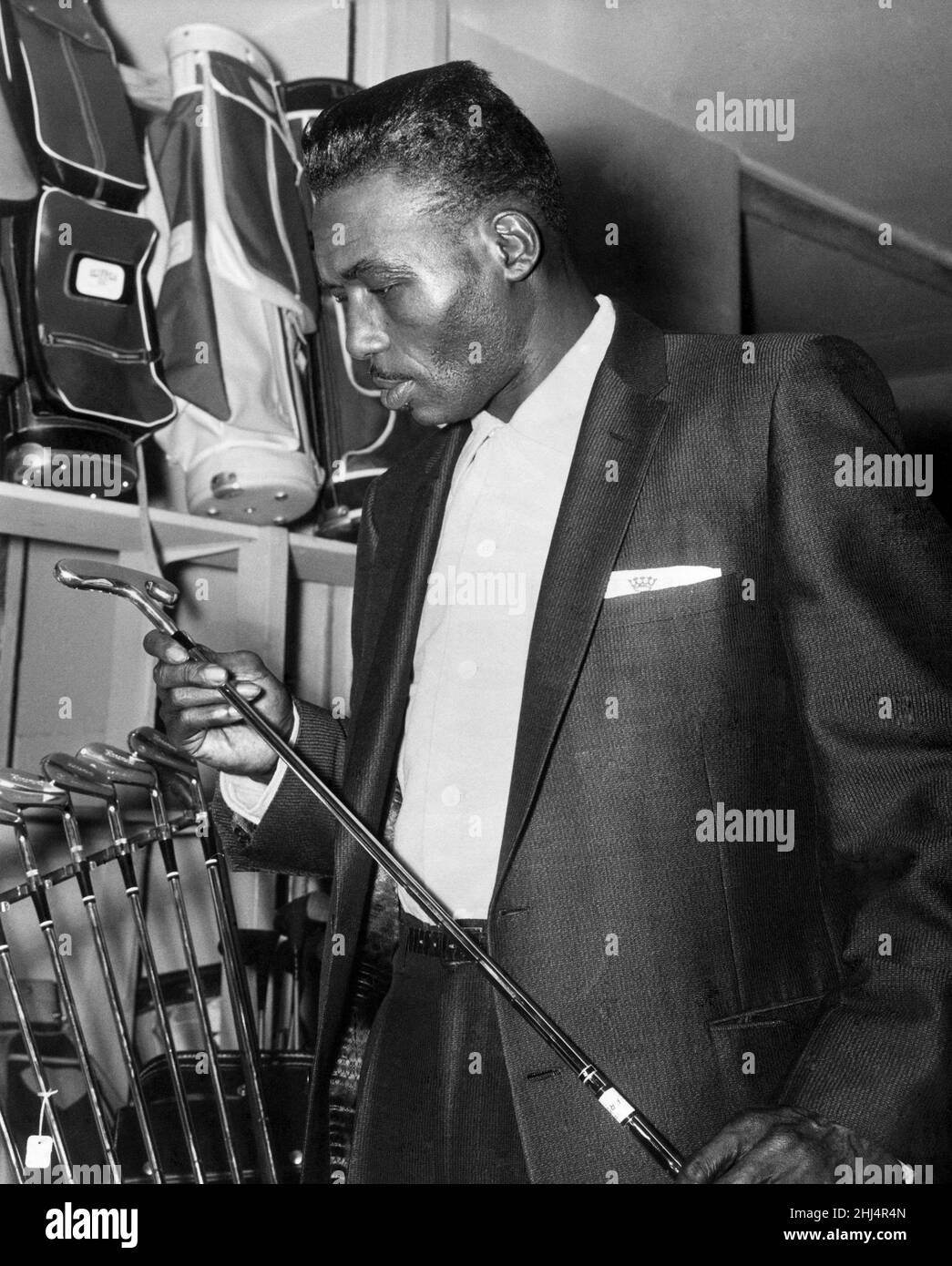 Joey Brown tries out golf clubs at a big London departmental store ...