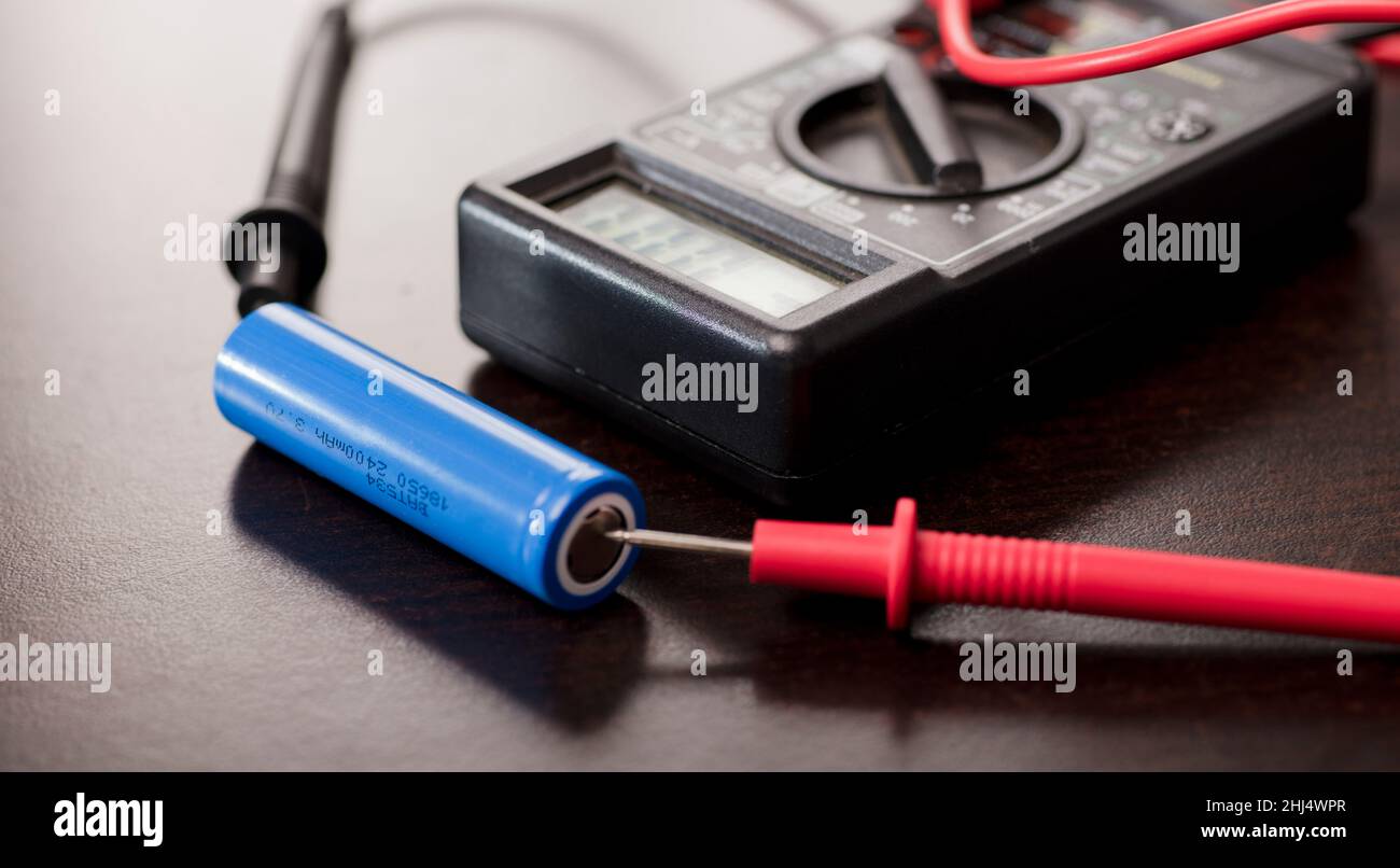 battery with volt calculator, voltmeter, multimeter red positive pole ...