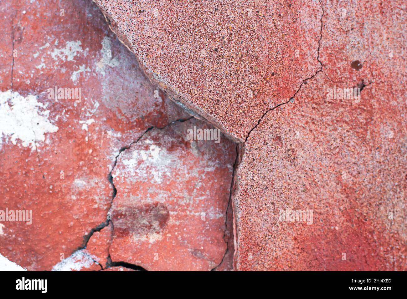 Red wall. The old wall is crumbling. Texture of brickwork. The top ...