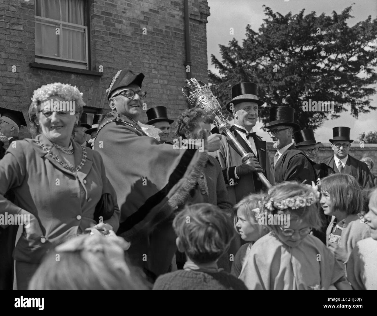 Cambridge mayor Leonard D. V. Wordingham throws pennies to the children ...