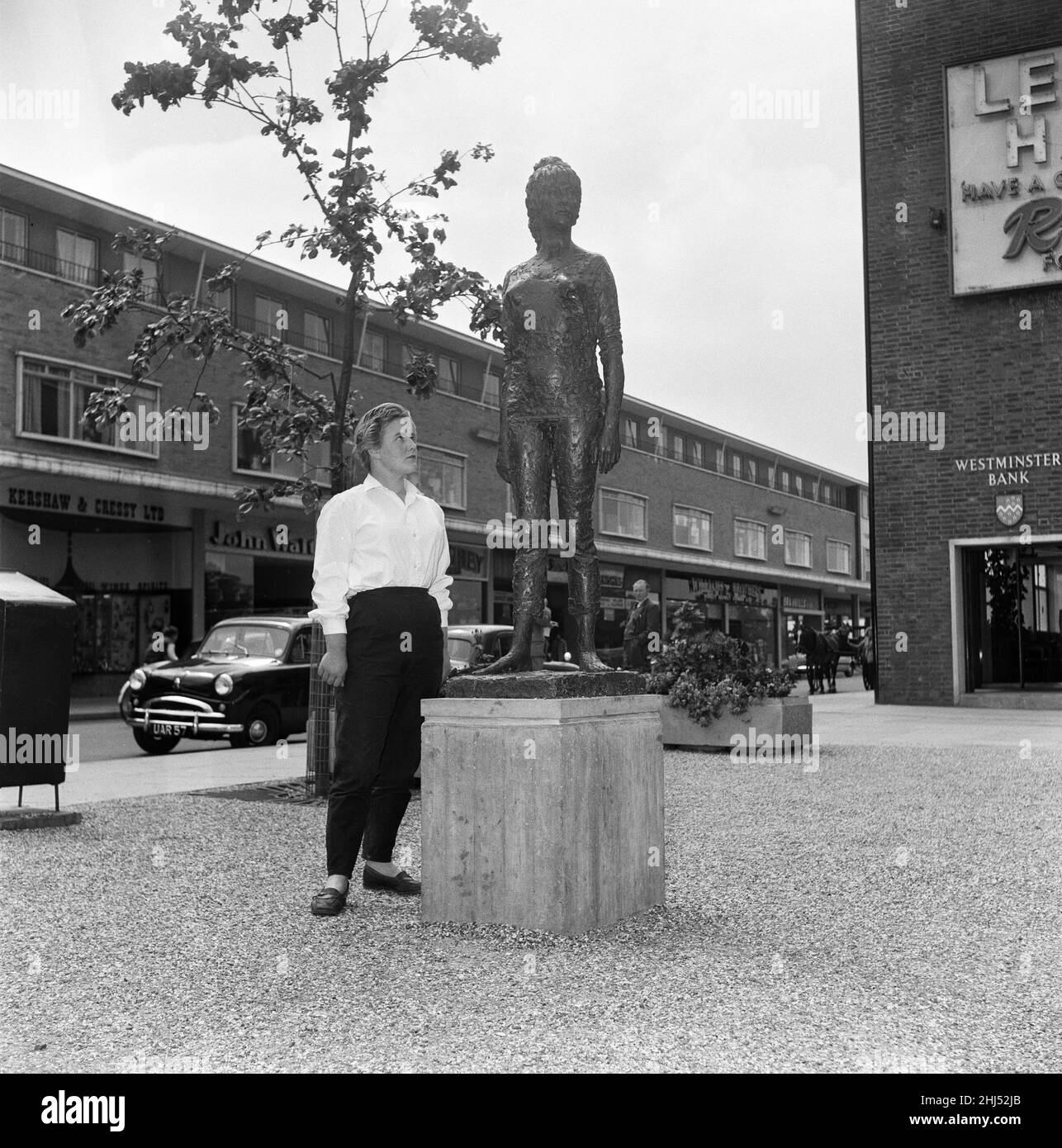 A modern girl in jeans standing next to the statue of Elisabeth Frink ...