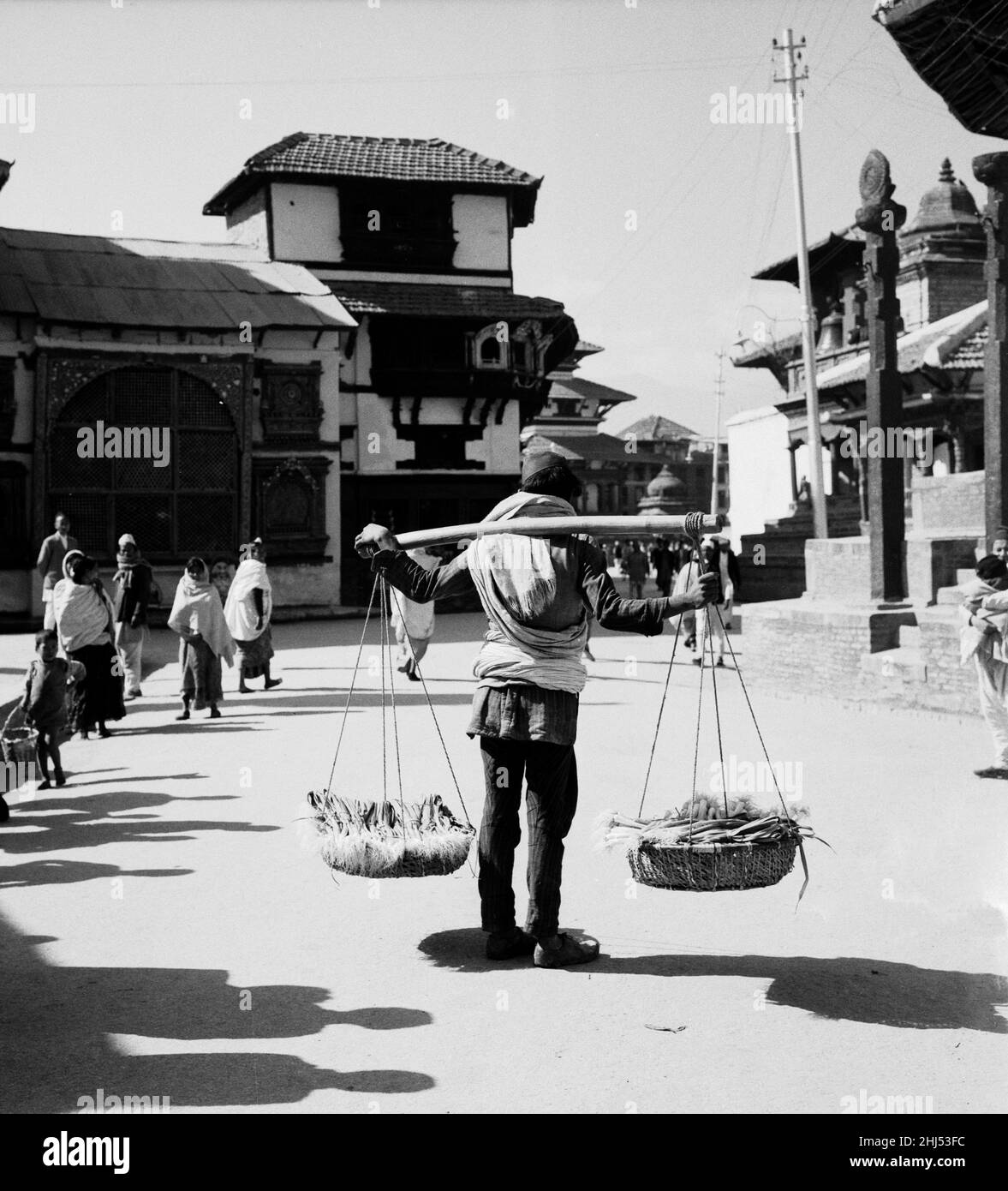 A Nepalese market trader seen here carrying his onions to market in ...