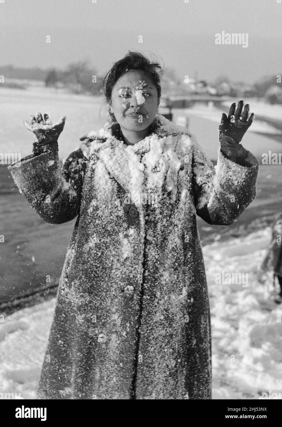 Philippine dancers have a snowball fight in London. One of the woman ...