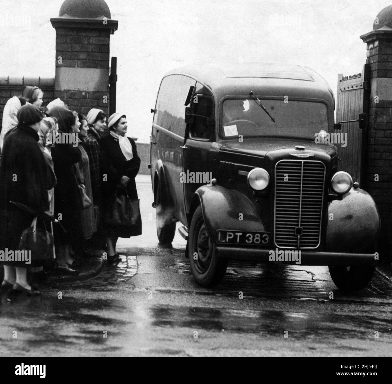 A small group of woman watch an enclosed police van leave Jarrow today ...