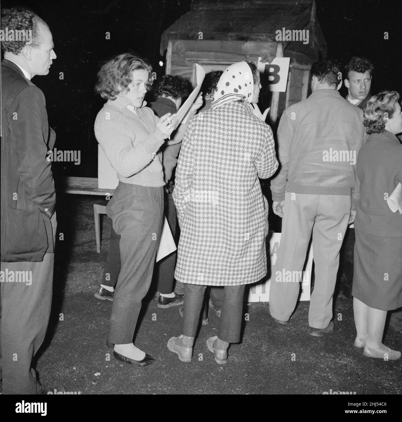 British racing drivers Pat Moss and Ann Wisdom check in looking tired ...