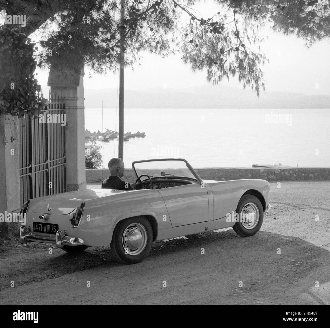 Daily Herald motor racing correspondent Thomas H Wisdom sitting at the ...