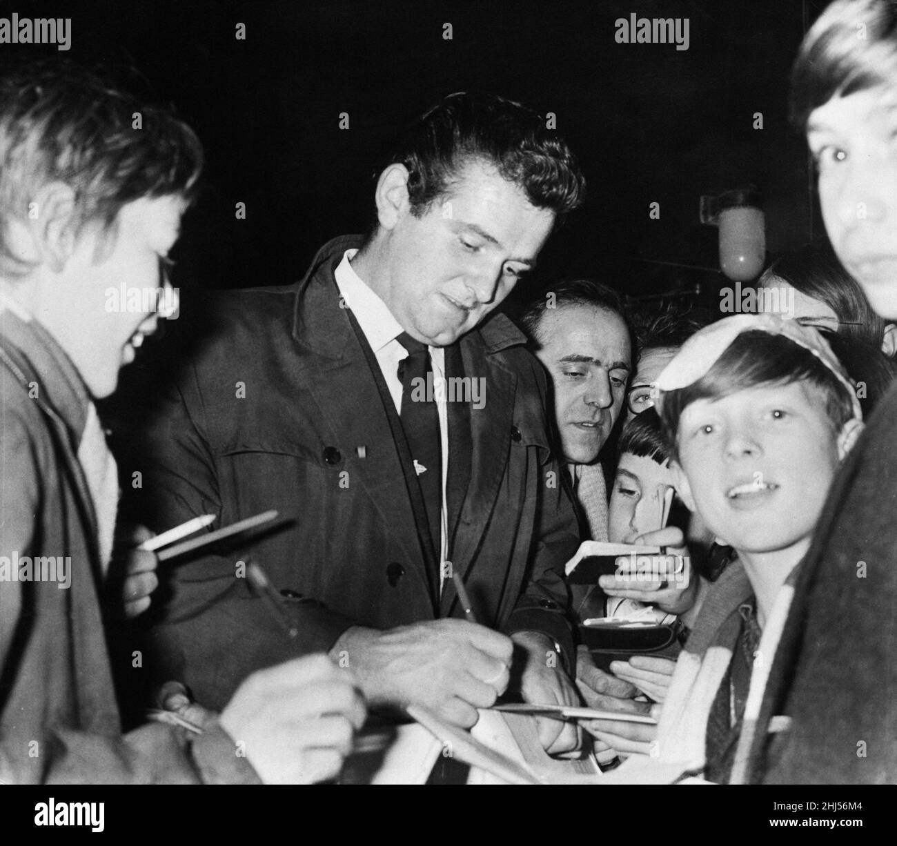 Tommy Lawrence signing autographs.Cica 1960s Stock Photo - Alamy