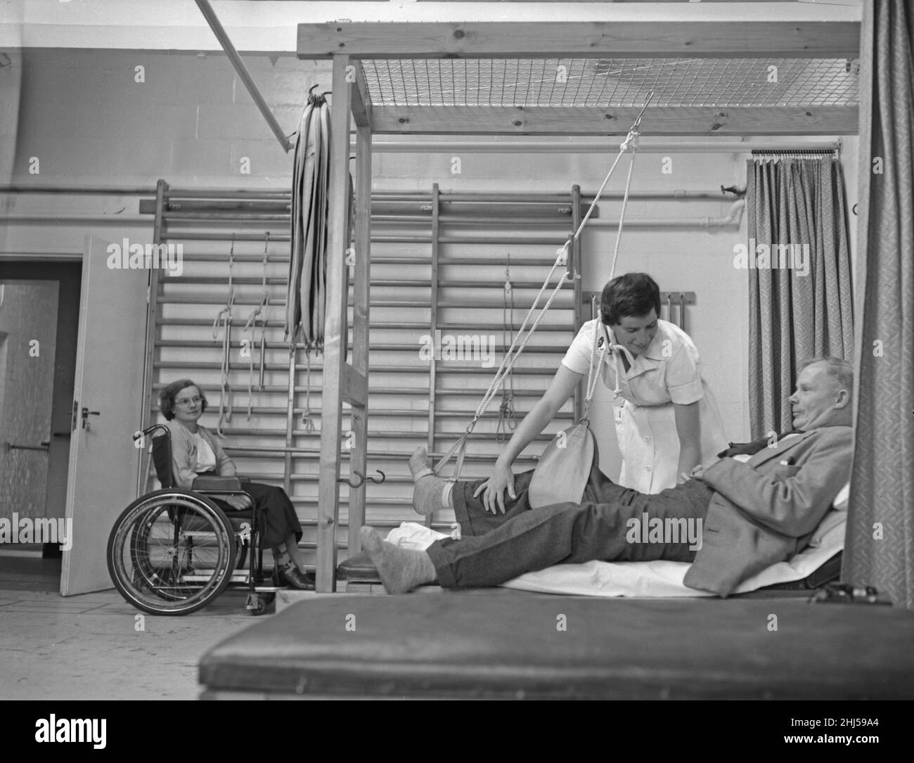 A nurse demonstrates how a sling for a broken leg works during a open ...