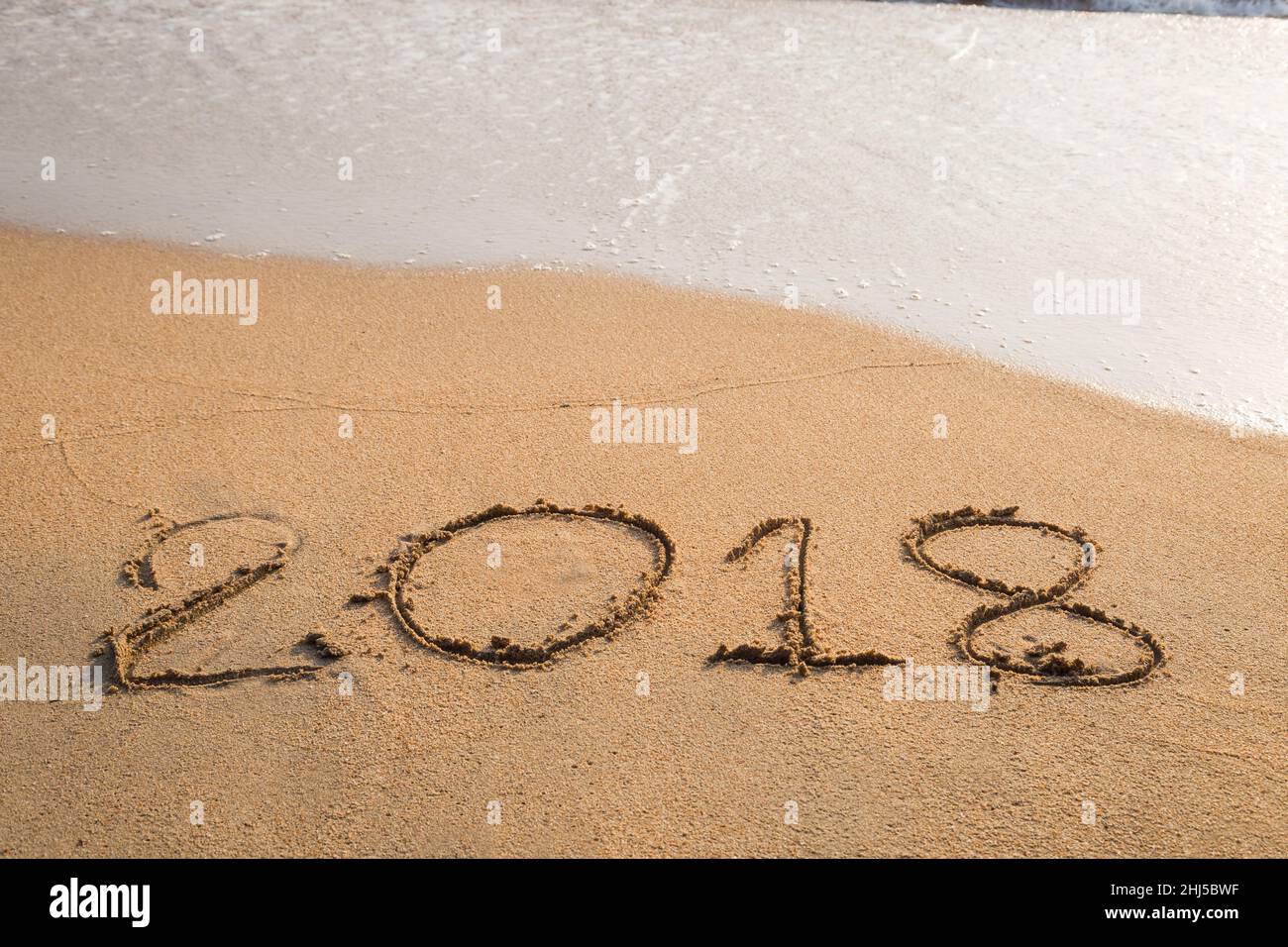 2018 message written in the sand at the beach background Stock Photo ...