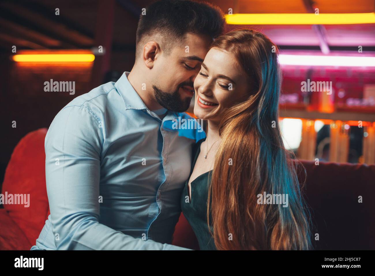 Young couple flirting at their first date at the restaurant. Valentine ...