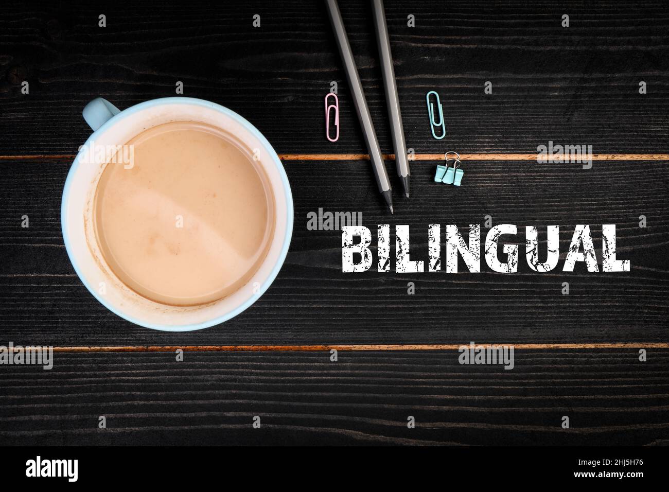 Bilingual. Text on a dark wooden background Stock Photo - Alamy