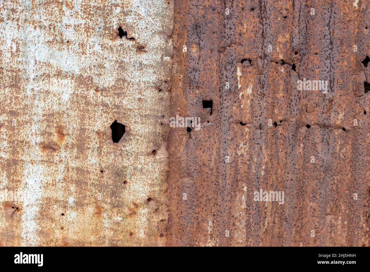 Rustic textured broken old wavy metal sheet with holes for background ...