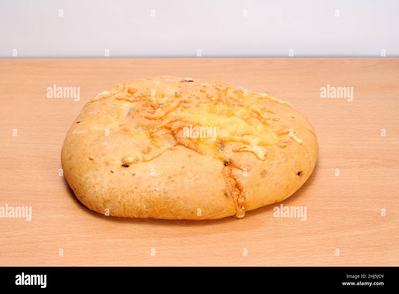 Round flat loaf of white bread with cheese Stock Photo - Alamy