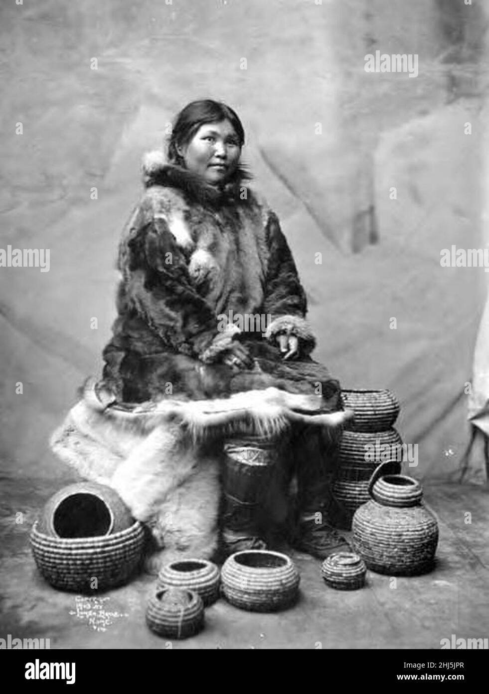 Studio portrait of Eskimo woman dressed in moose fur parka with seal ...