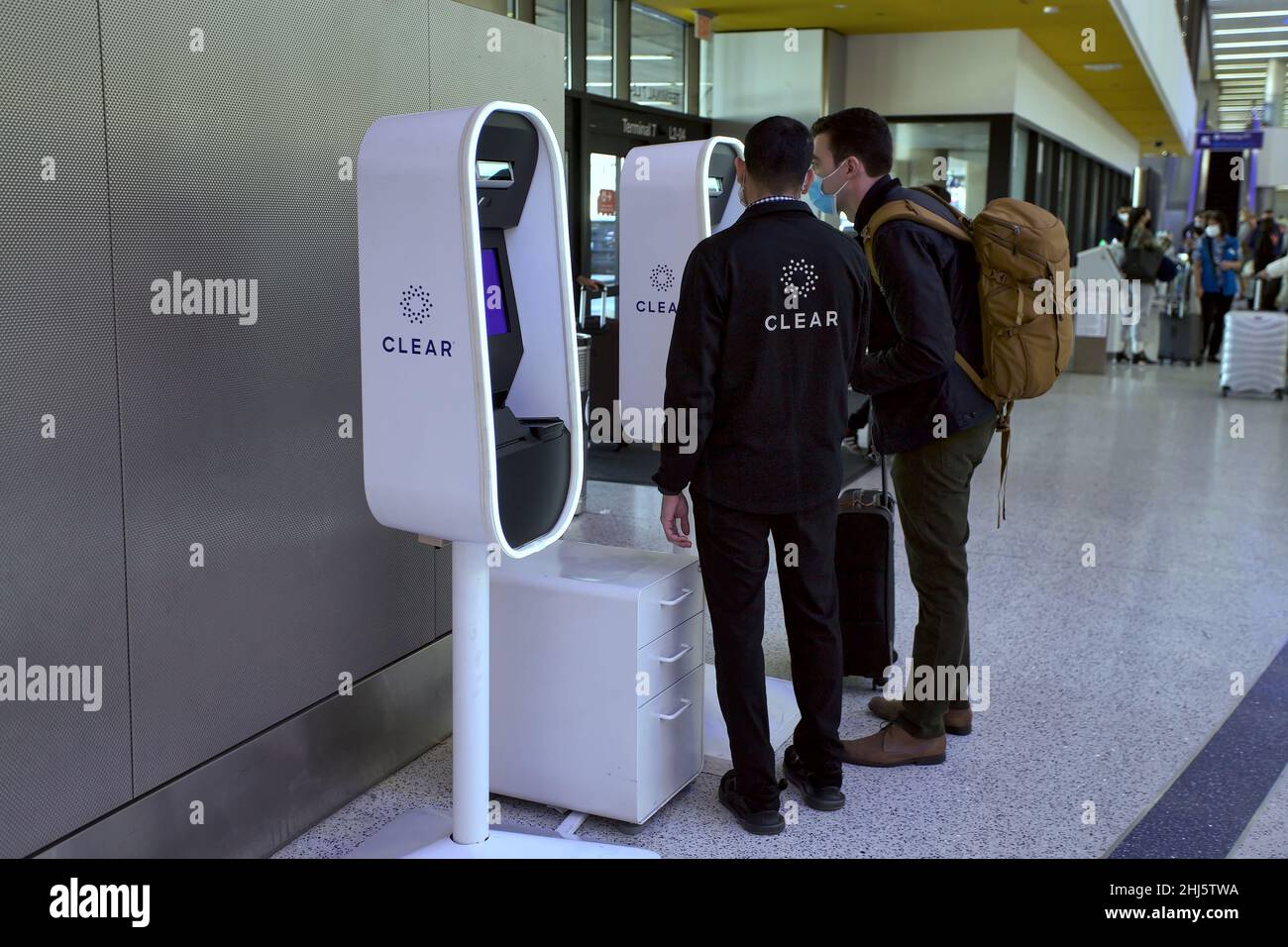 A CLEAR service rep helps a passenger at Los Angeles Airport Stock ...