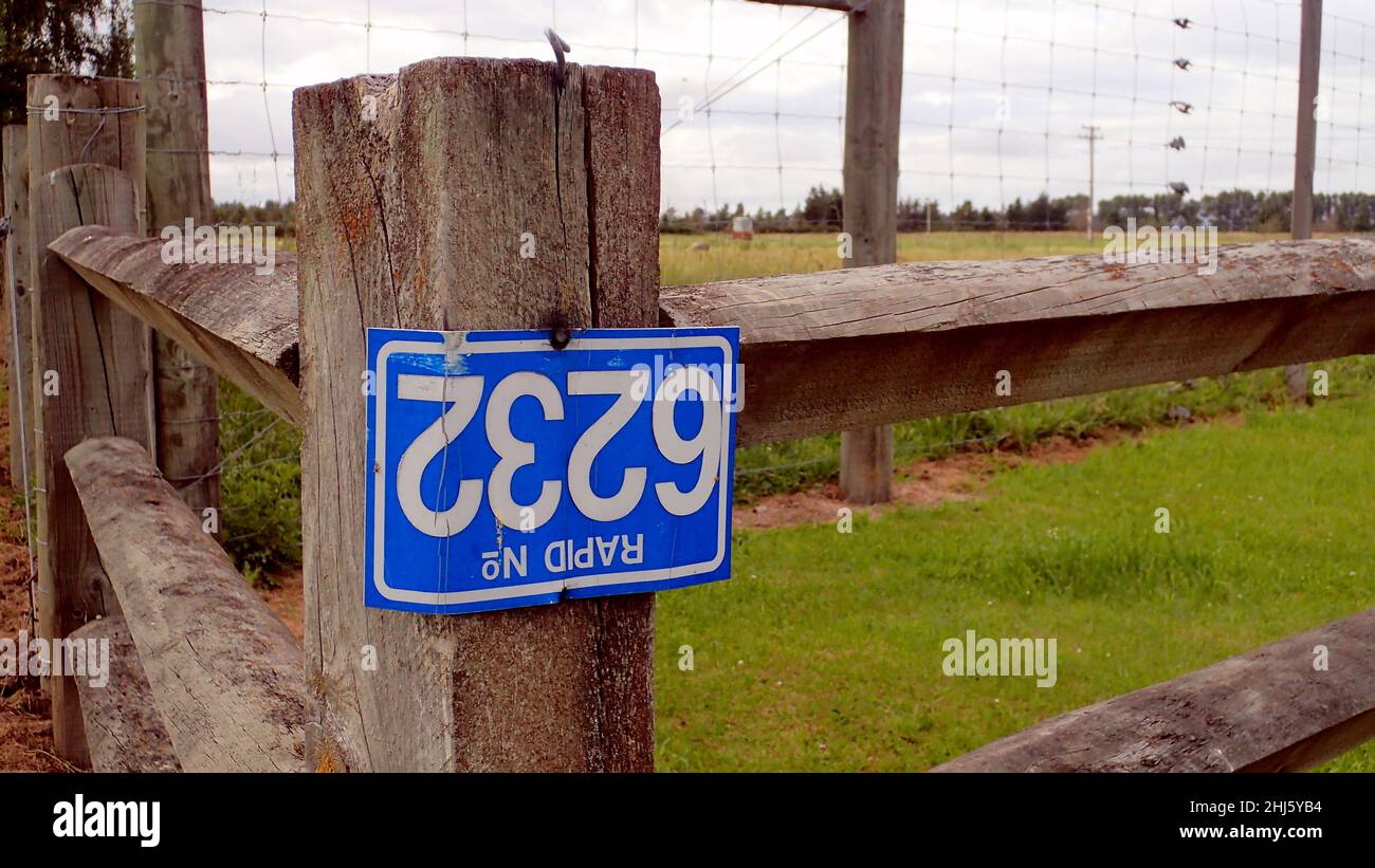 Upside down number signage on wooden fencing around a farm Stock Photo ...