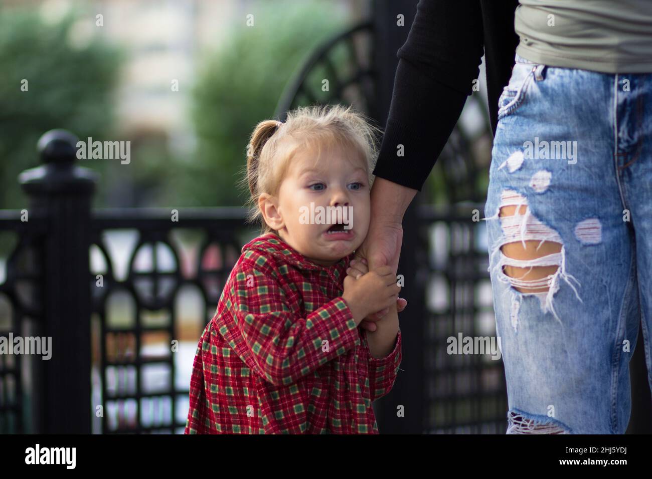 Funny and scared face of caucasian child of two years old holding ...
