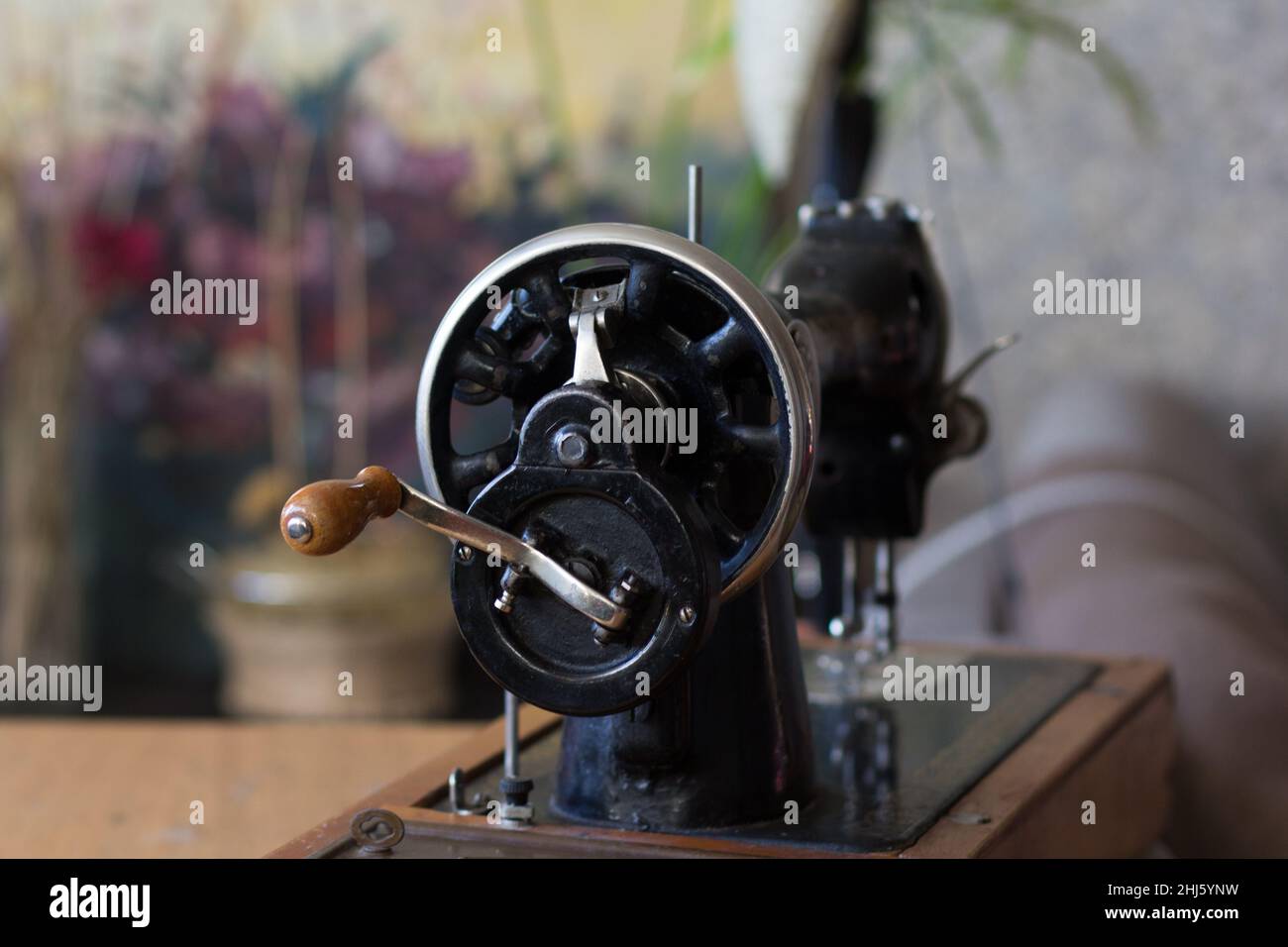 Machine pulley with wooden handle as part of old manual sewing machine ...