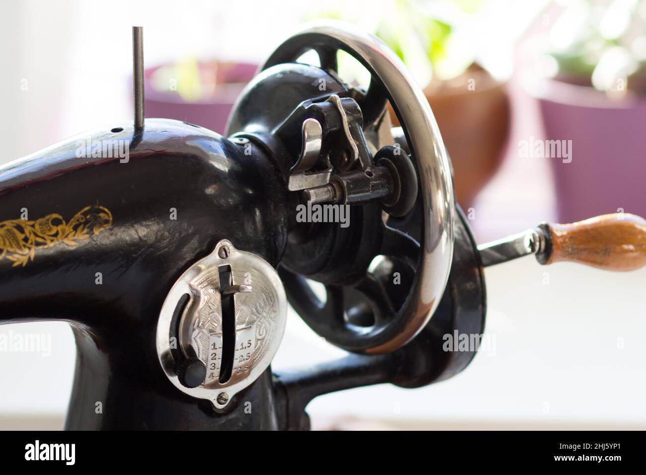 Machine pulley with wooden handle as part of old manual sewing machine ...