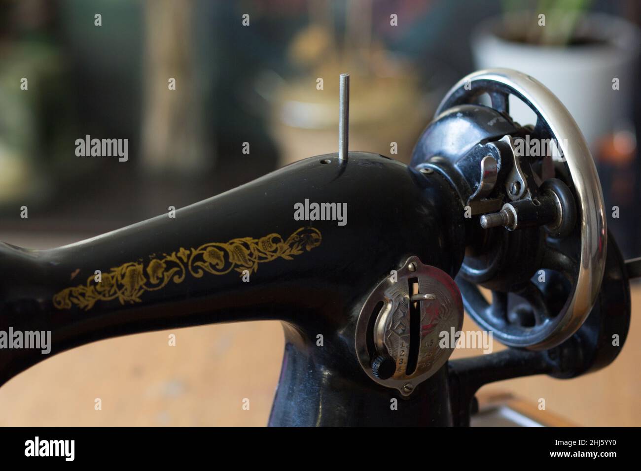 Machine pulley with wooden handle as part of old manual sewing machine ...
