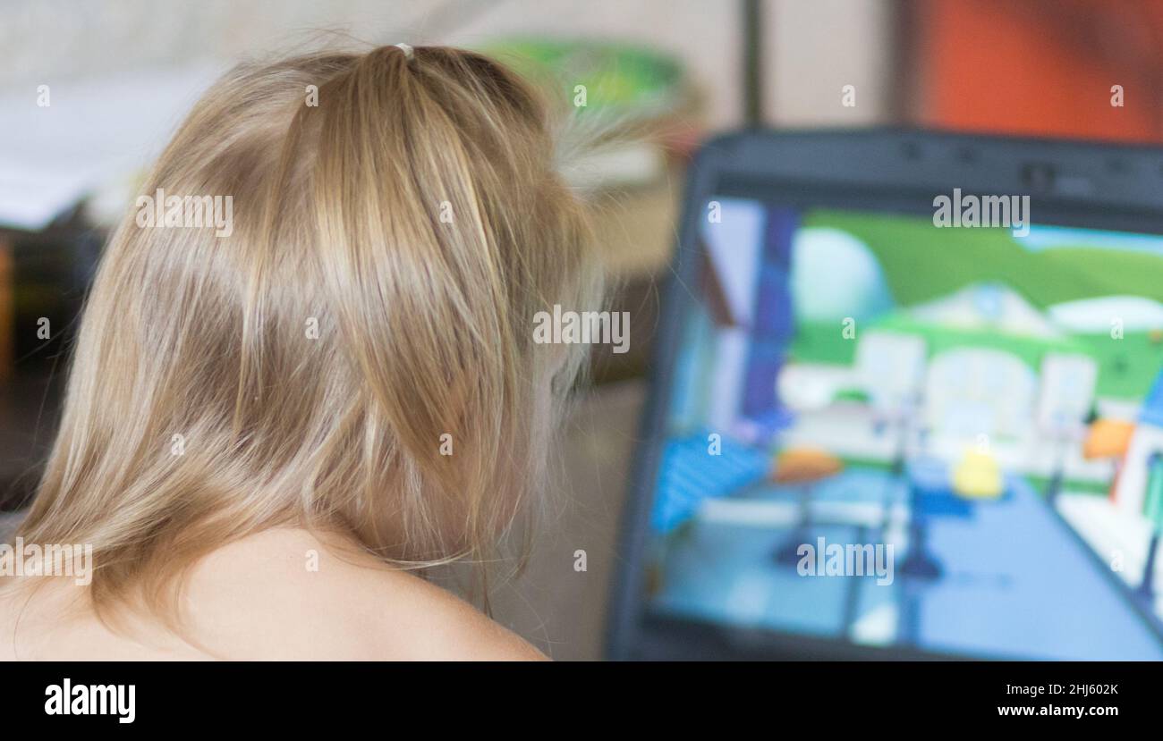 Back of head child looking at screen laptop watching cartoons Stock ...