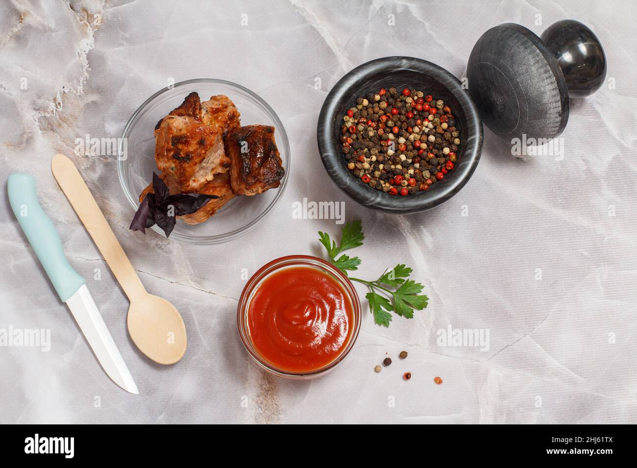 Grilled pork in a bowl with sauces and greens Stock Photo - Alamy