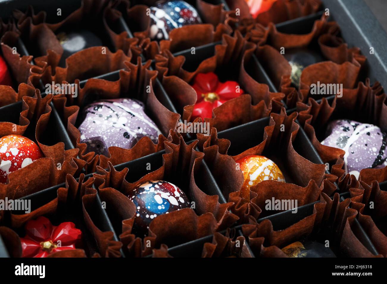 A set of colorful exclusive handmade chocolates in a package Stock ...