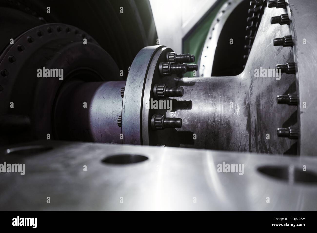 A gas turbine with a compressor rotor and a bolted coupling half ...
