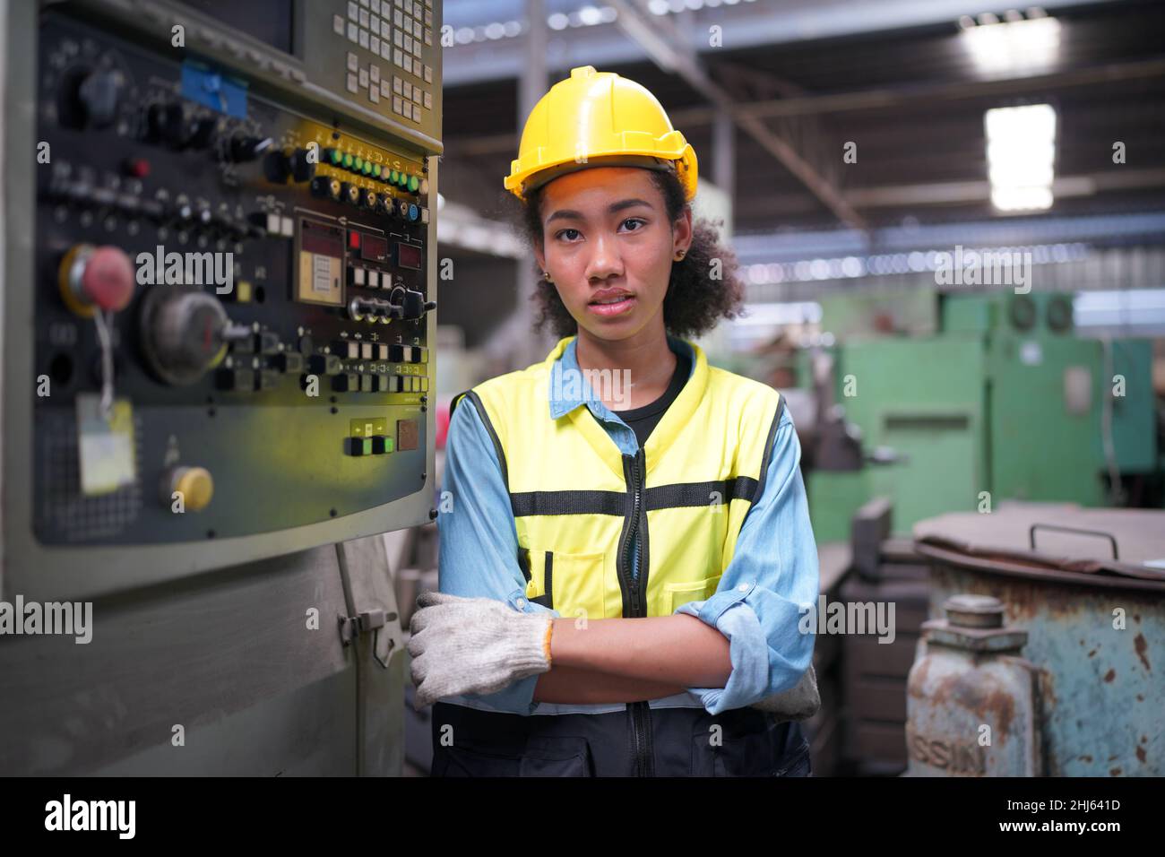 Female apprentice in metal working factory, Portrait of working female ...