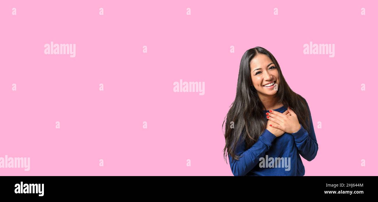 Young woman showing her heartfelt gratitude and thanks clasping her ...