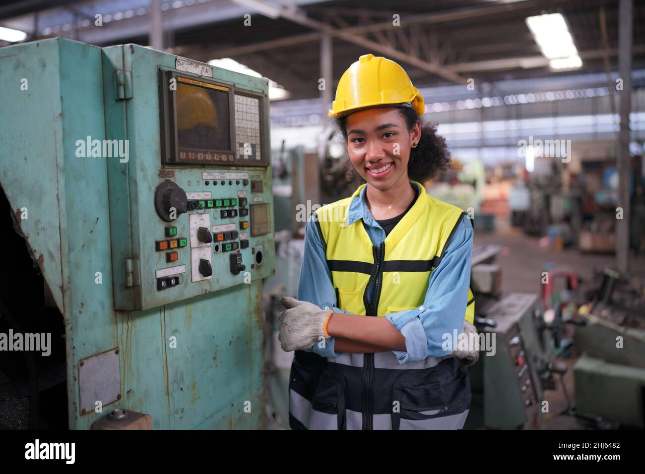 Female apprentice in metal working factory, Portrait of working female ...