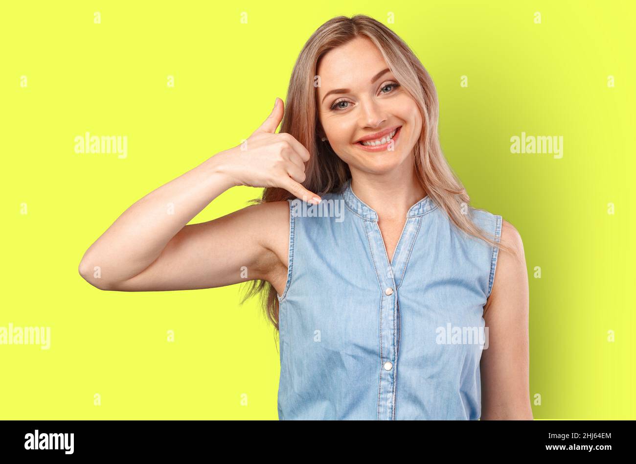 Woman with call me gesture posing on isolated color background Stock ...